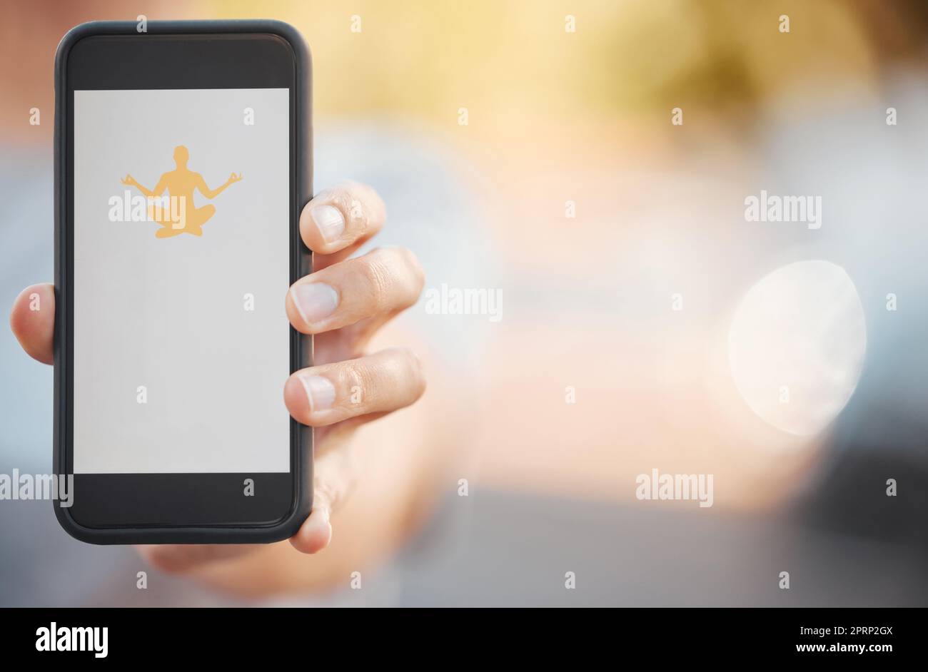 Hand with phone on yoga online app and screen with mockup outdoor ...