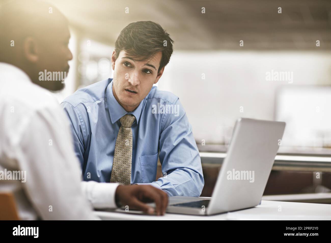 He values his input. two businessmen discussing work in the office ...