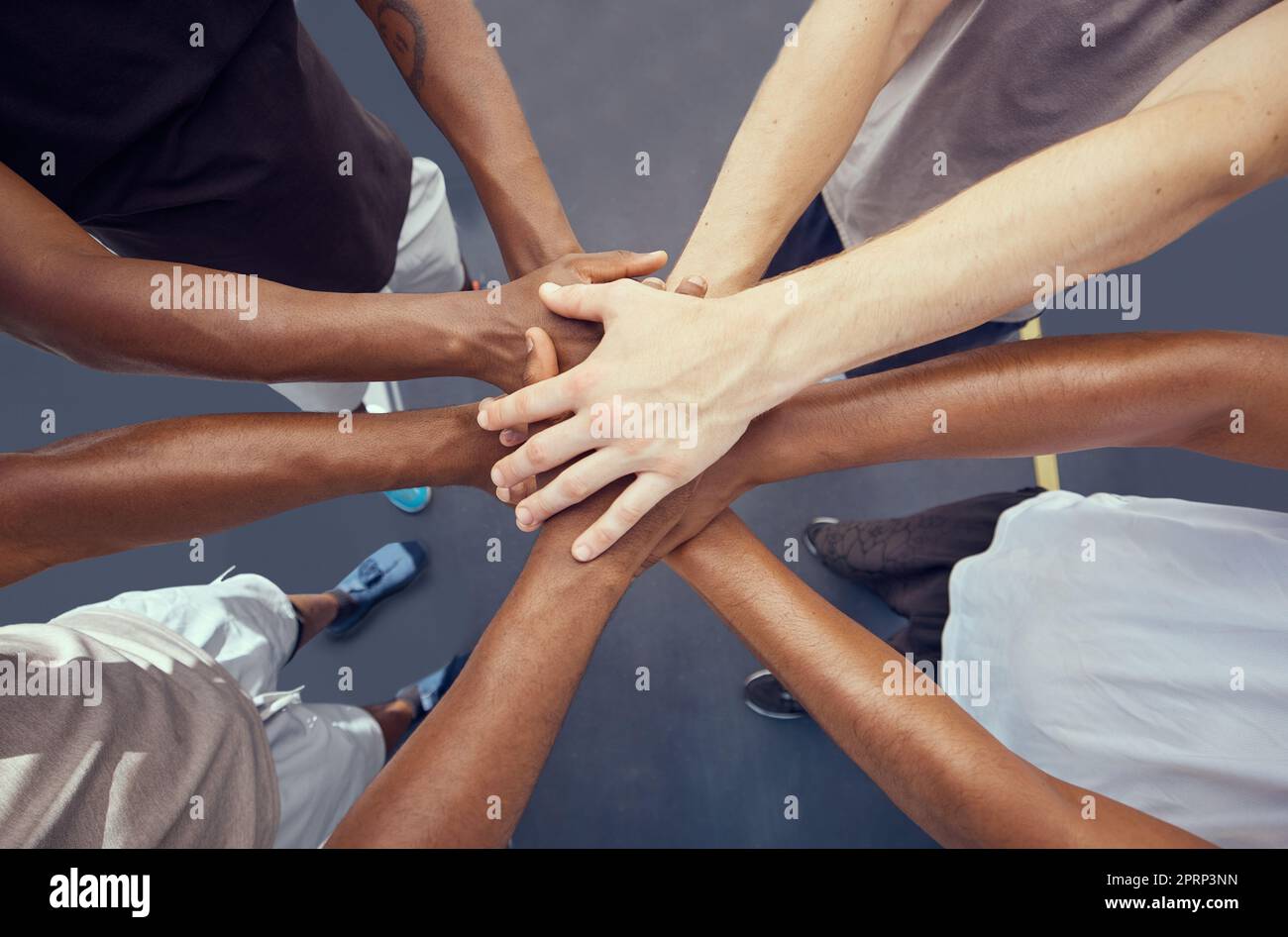 Teamwork, solidarity and diversity sports people hands stacked together from above. Athlete ...