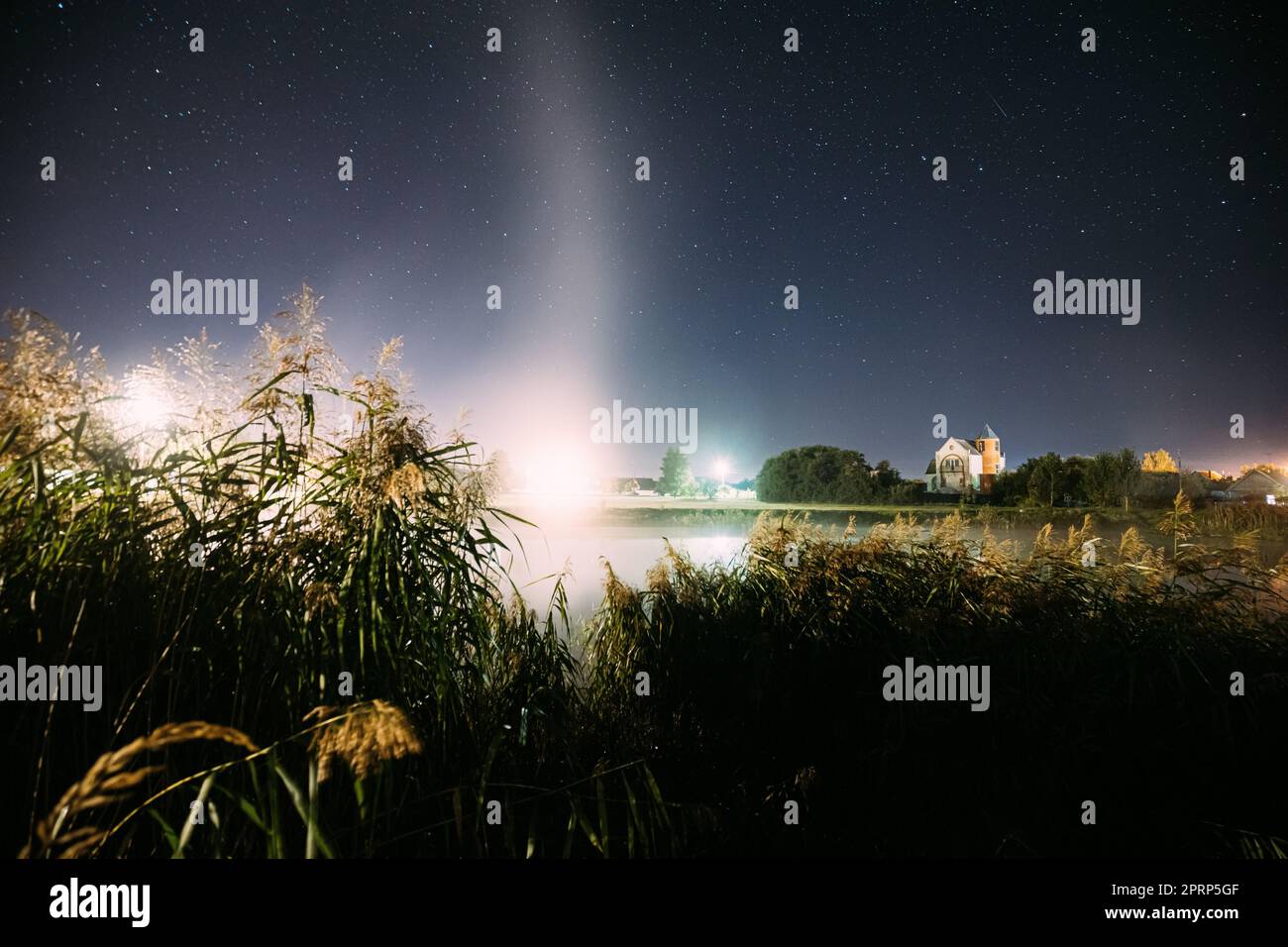 Evaporation Over River Lake Near Houses In Village. Night Starry Sky ...