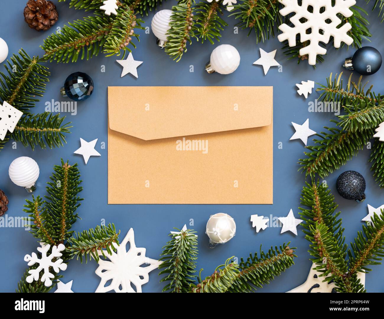 Craft paper envelope on a blue background near white Christmas ...