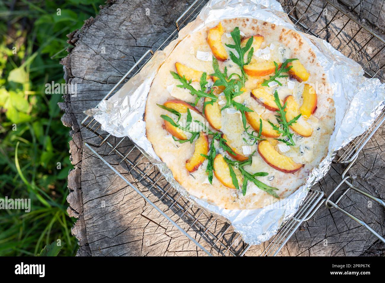 Very tasty and interesting pizza with peach and dor blue with arugula ...