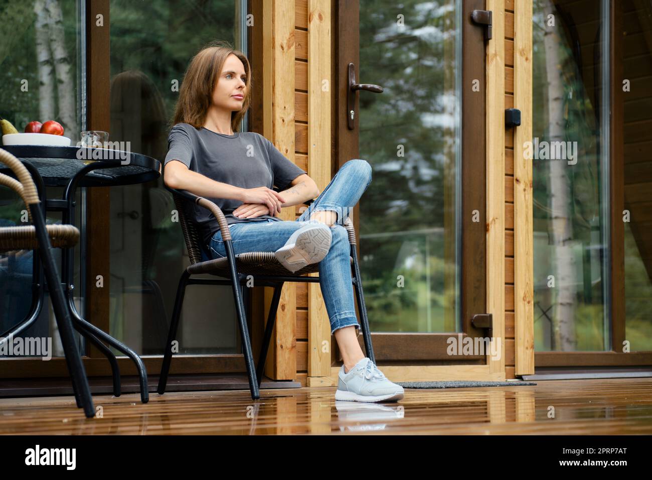 A lovely young woman is resting in silence in her country house Stock ...