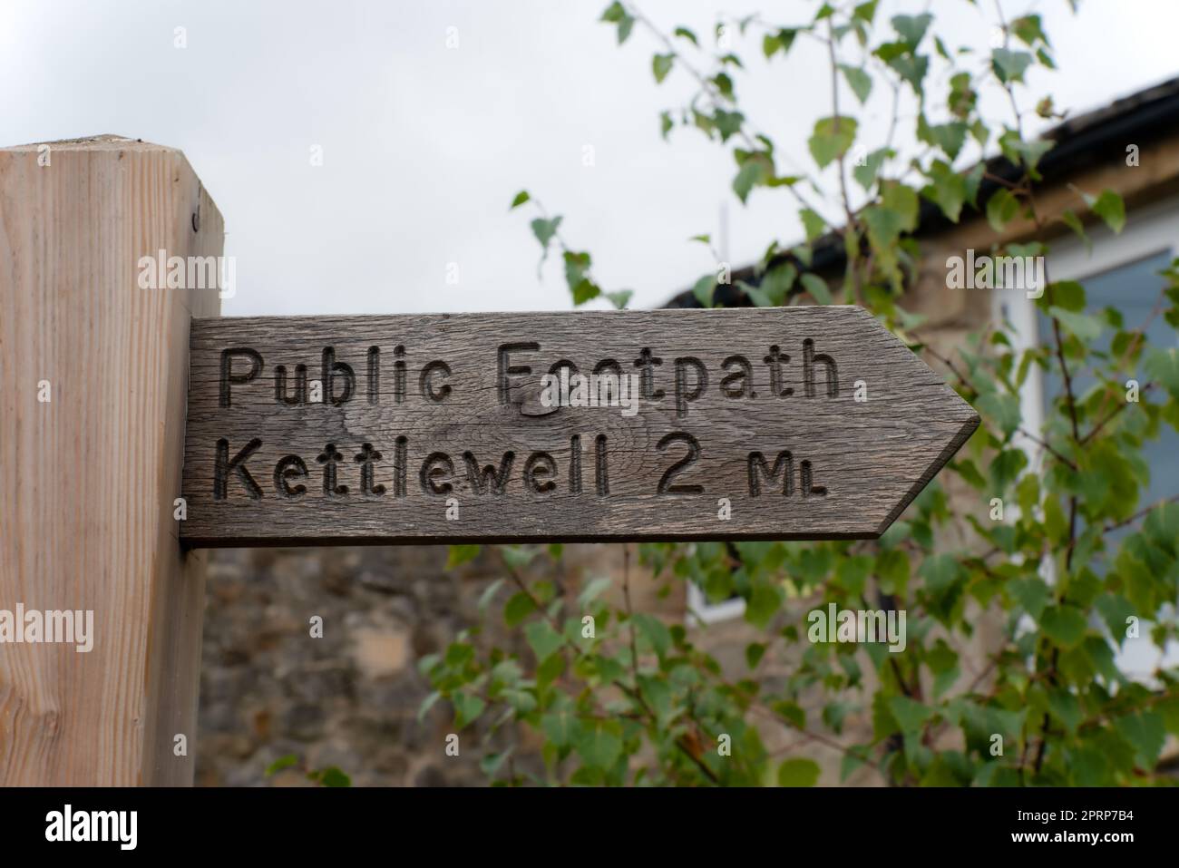 Wooden signpost "Public Footpath Kettlewell" in the Wharfdale in the ...