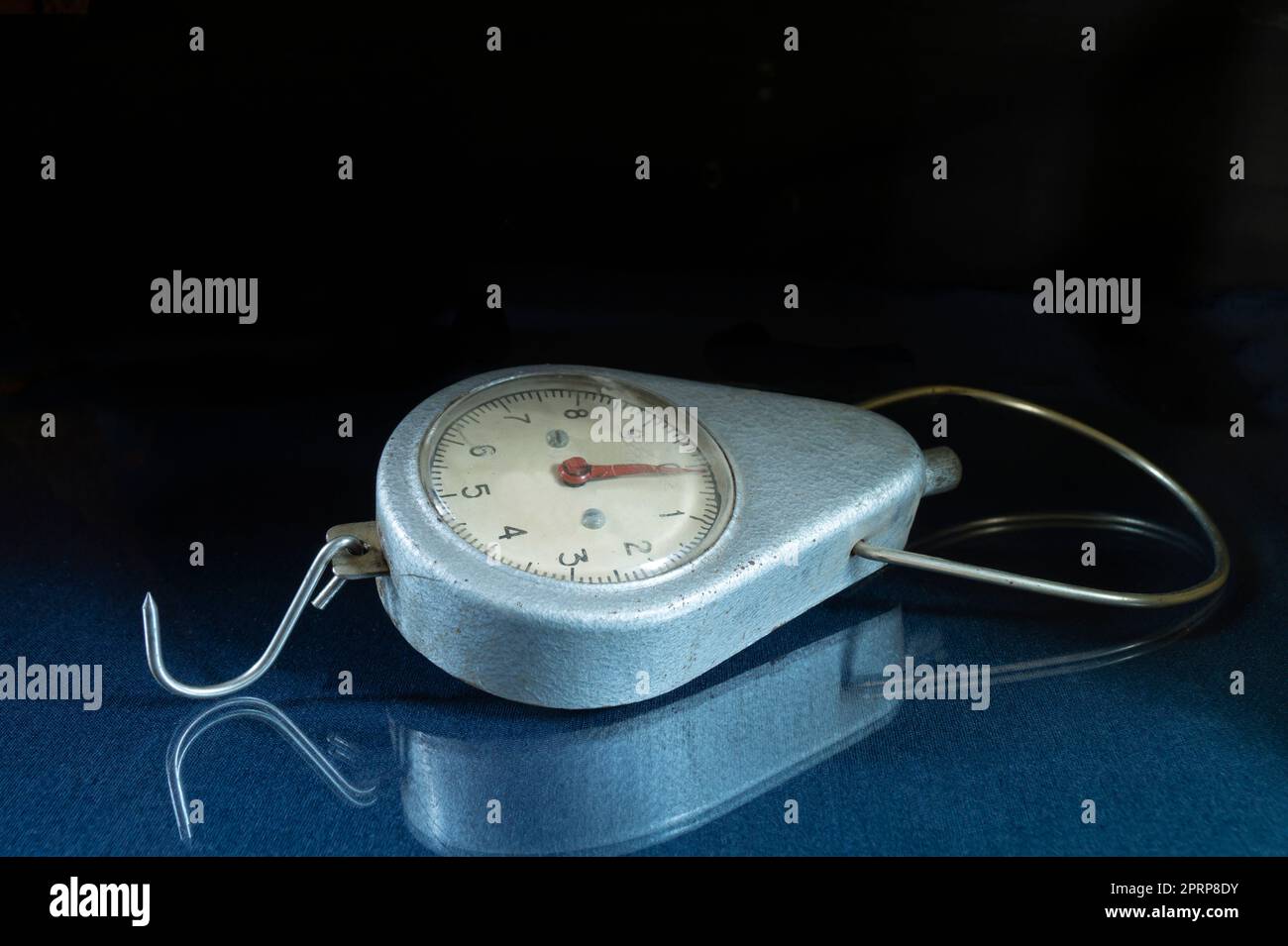 A metal object with a reflection. Household tools on a black background ...