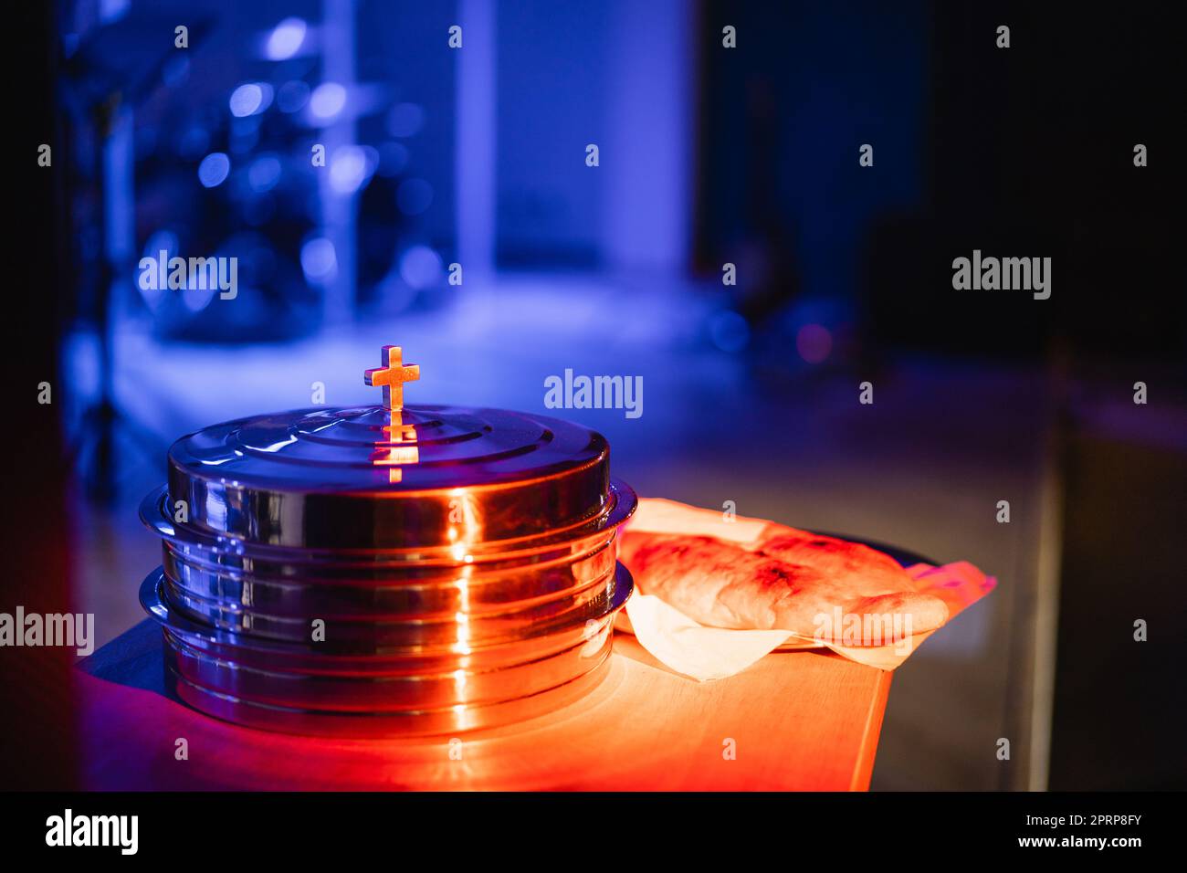 The process of breaking bread in the modern church Stock Photo - Alamy