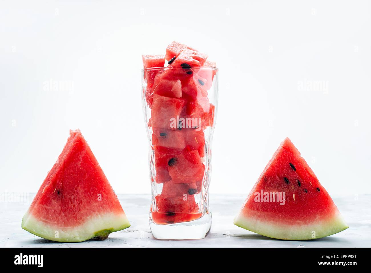 a front view sliced fresh watermelon sweet and mellow on the white desk ...