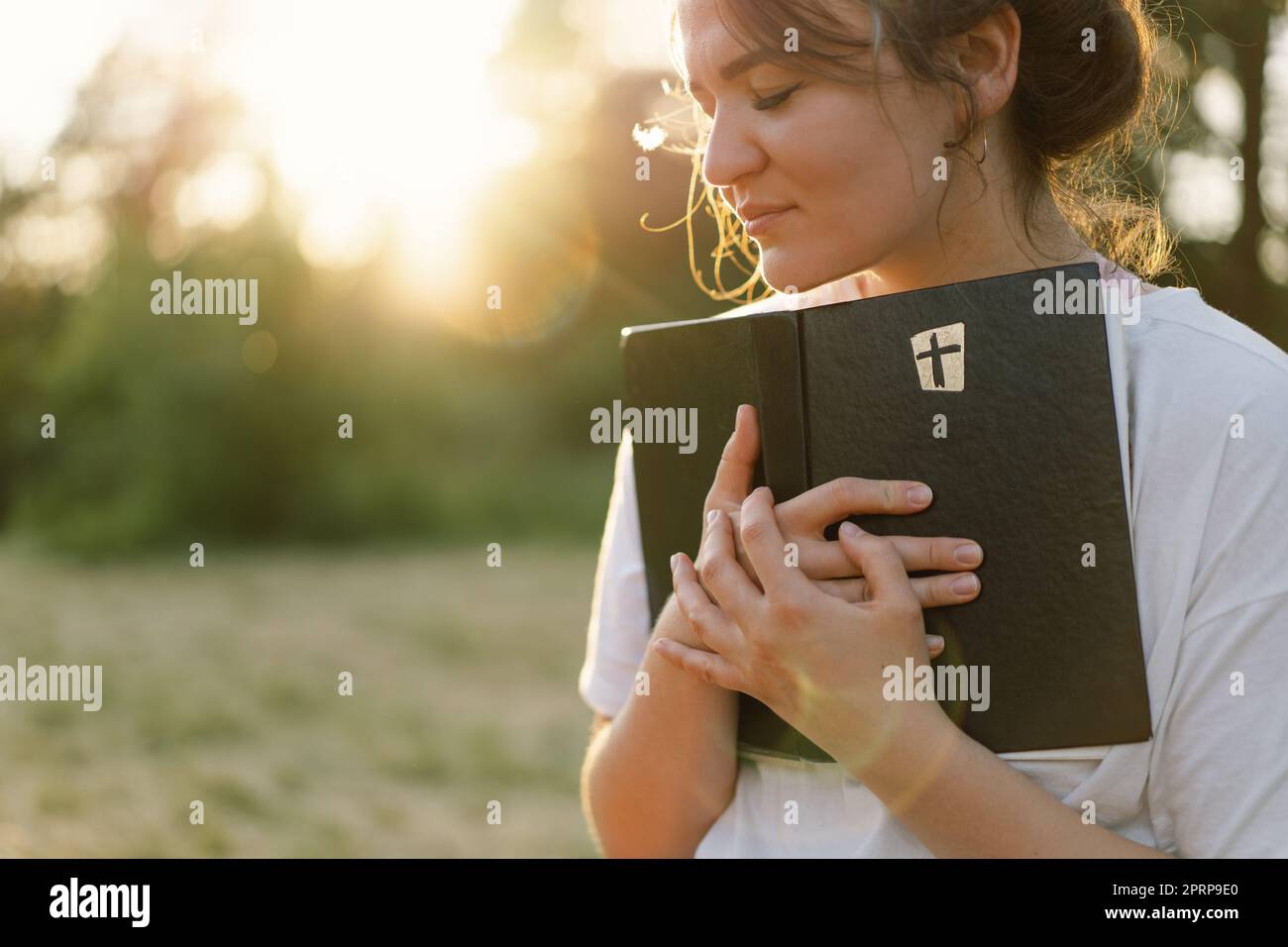 Christian woman holds bible in her hands. Reading the Holy Bible in a ...