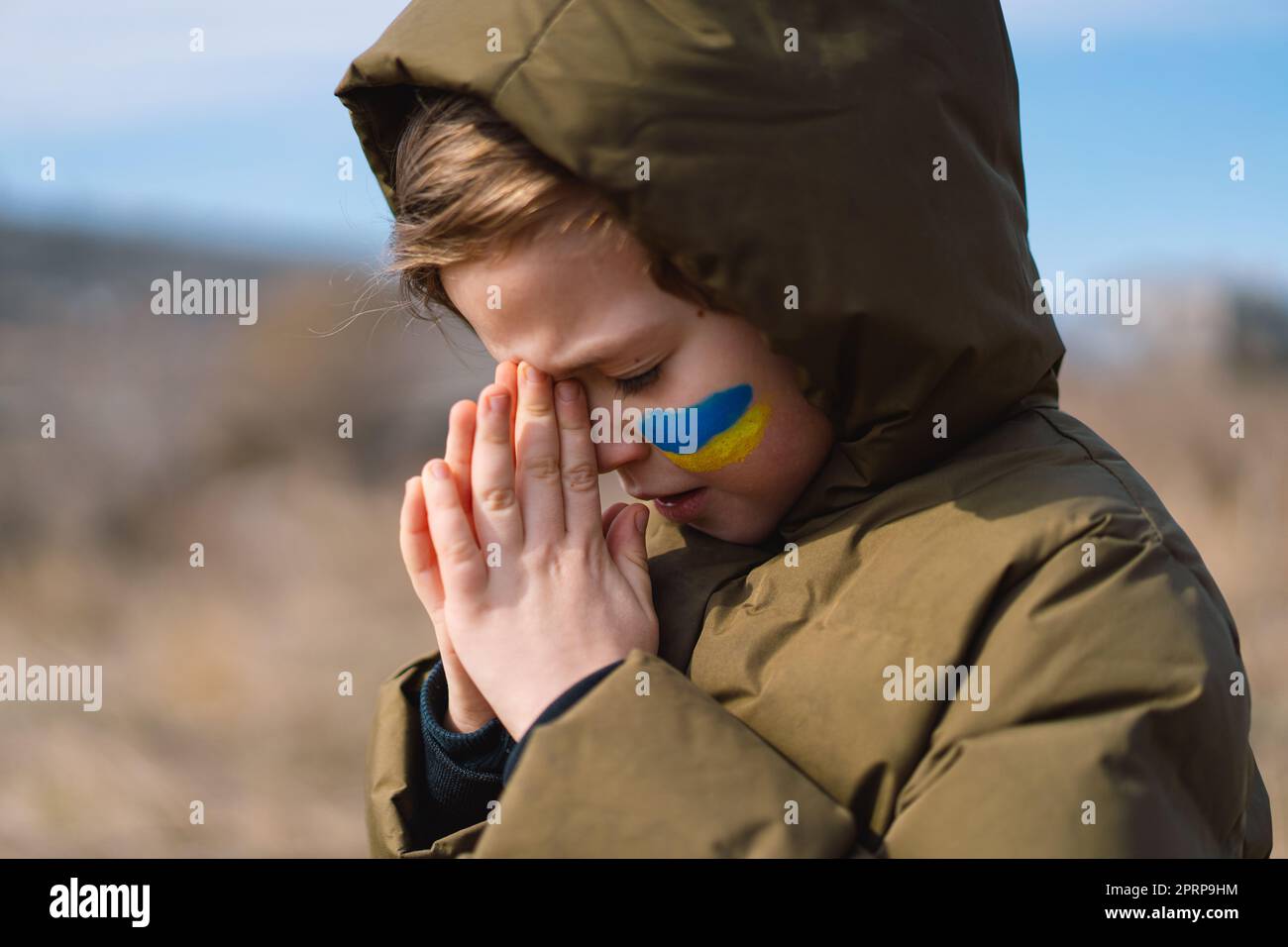 Ukrainian boy closed her eyes and praying to stop the war in Ukraine ...