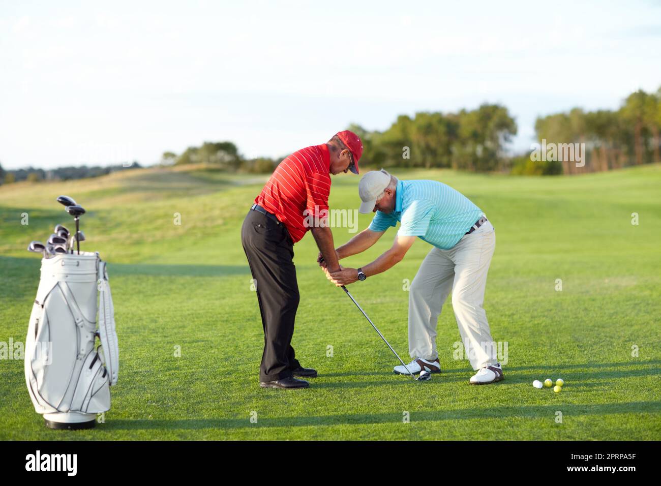 You want to line it up like this...A male golfer getting assistance ...