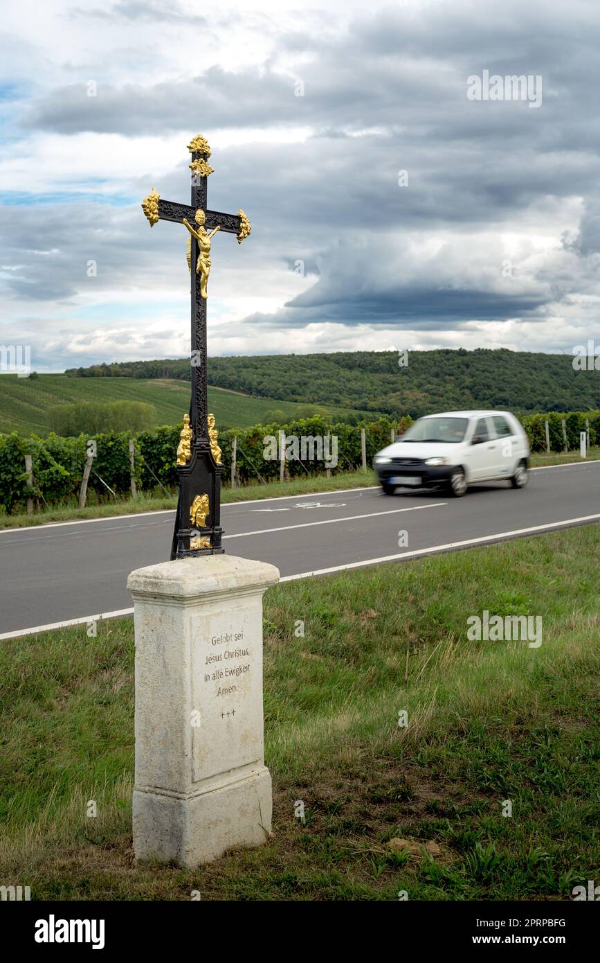 religious cross near a road with car Stock Photo - Alamy