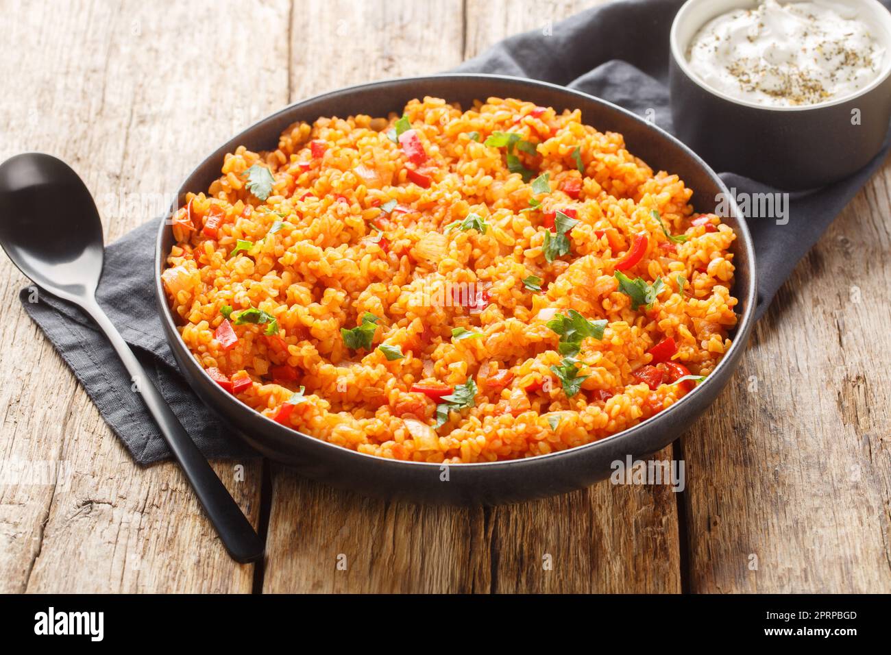 Turkish pilaf from bulgur with vegetables and spices close-up in a bowl ...