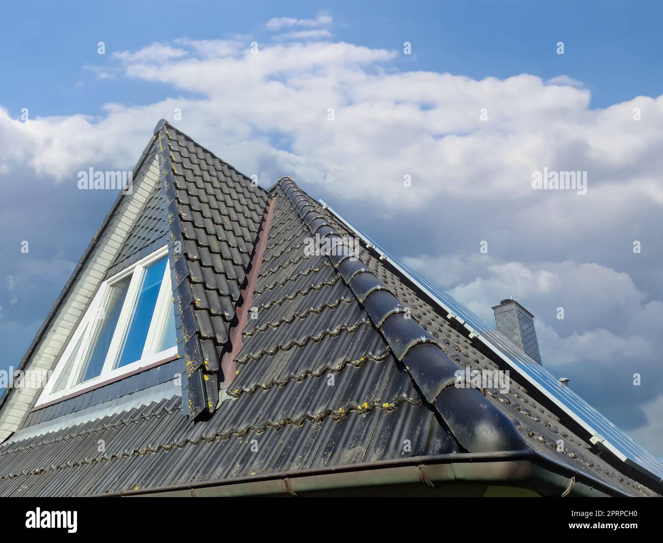 Roof window in velux style with black roof tiles Stock Photo - Alamy