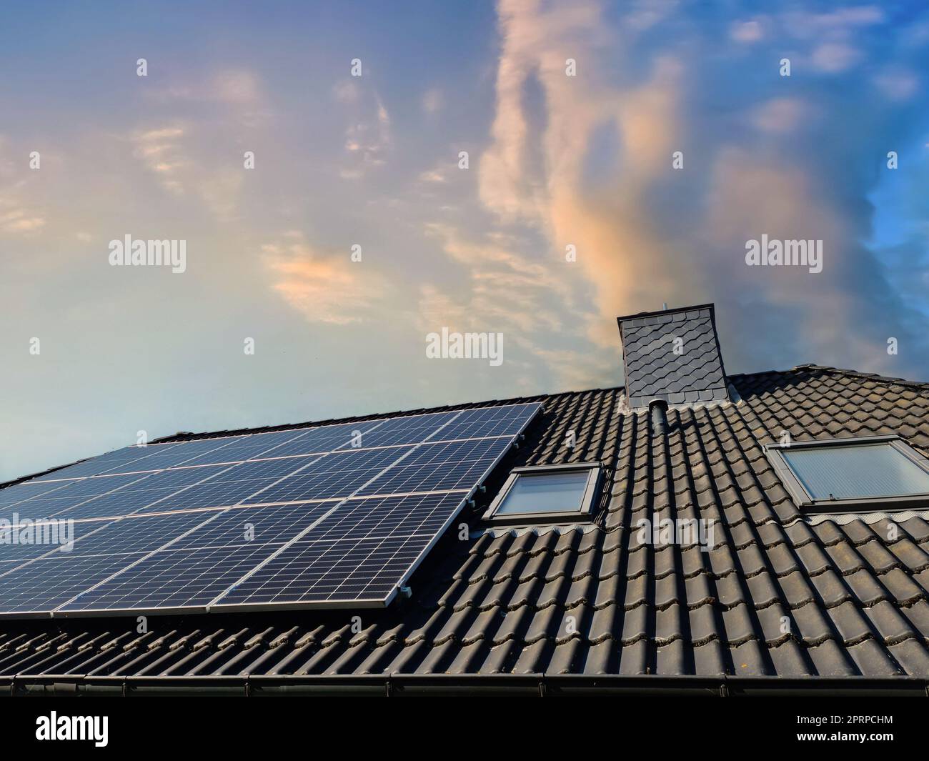 Solar panels producing clean energy on a roof of a residential house ...