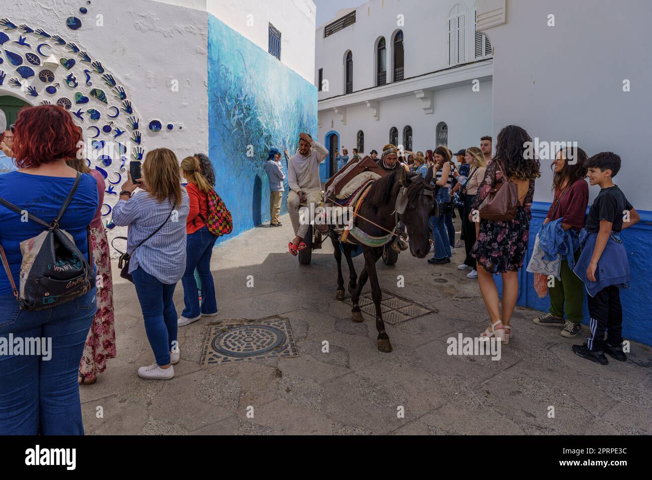 horse drawn carriage among crowd of tourists, Asilah, morocco, africa ...