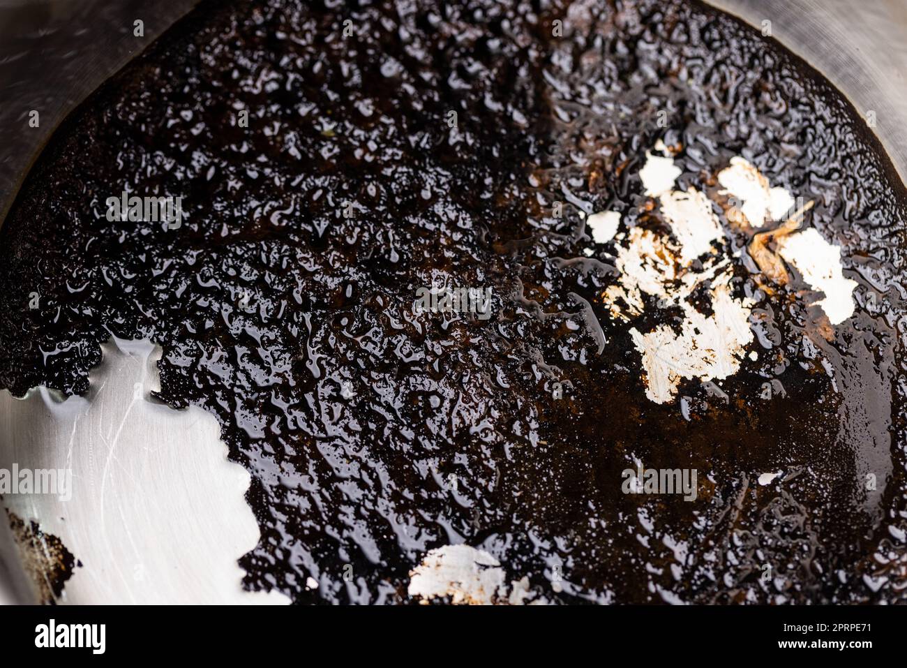 Kitchen utensil Burnt out metal pot Stock Photo - Alamy