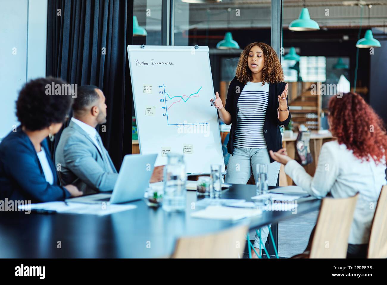 So heres the plan. a businesswoman giving a presentation to her ...