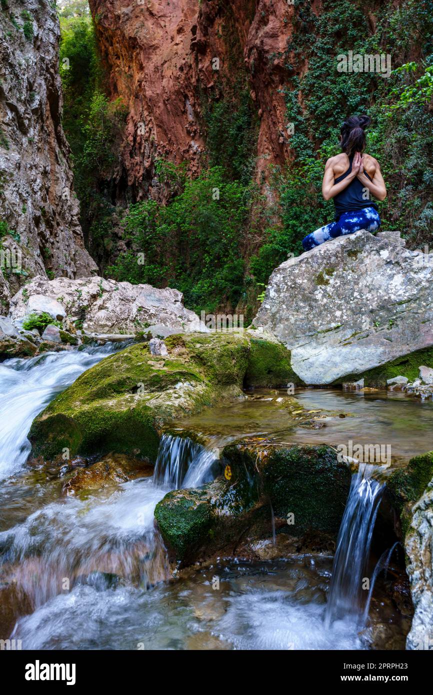 woman practicing yoga by the river, God's Bridge, Akchour, Talassemtane ...