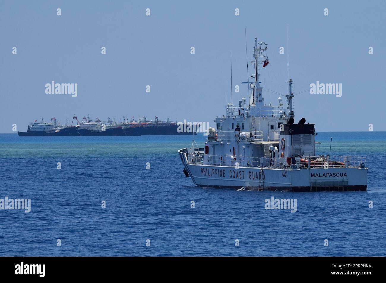 A Philippine Coast Guard ship approaches some of the many suspected ...
