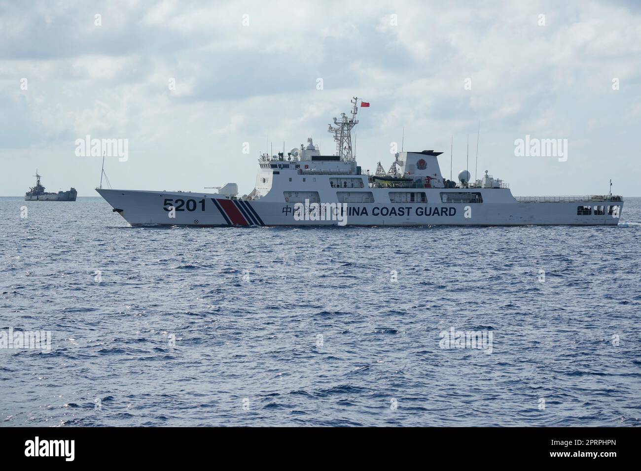 A Chinese Coast Guard ship, right, with bow number 5201 passes by now ...