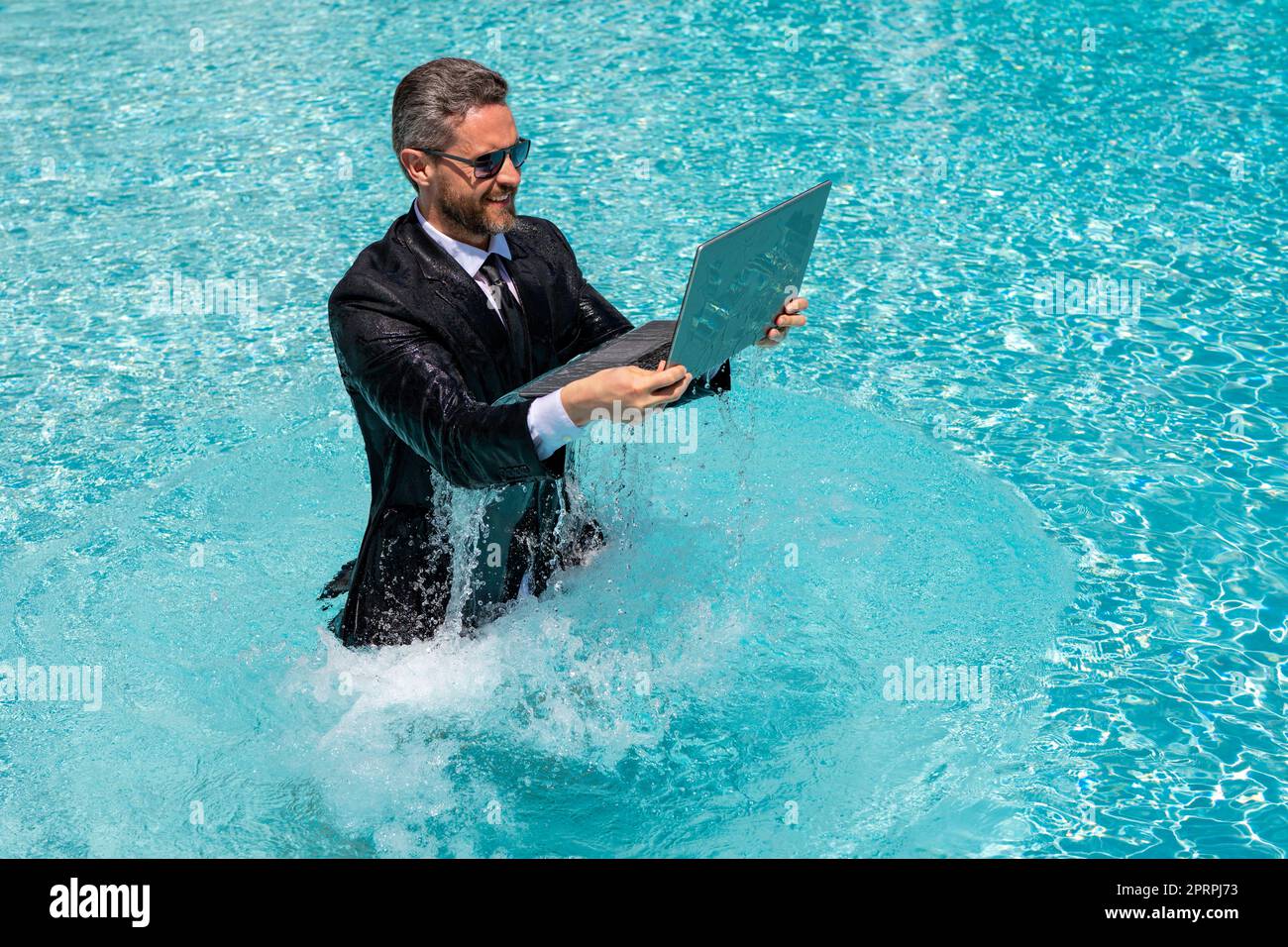 Successful excited business man in suit in pool water. Summer vacations ...