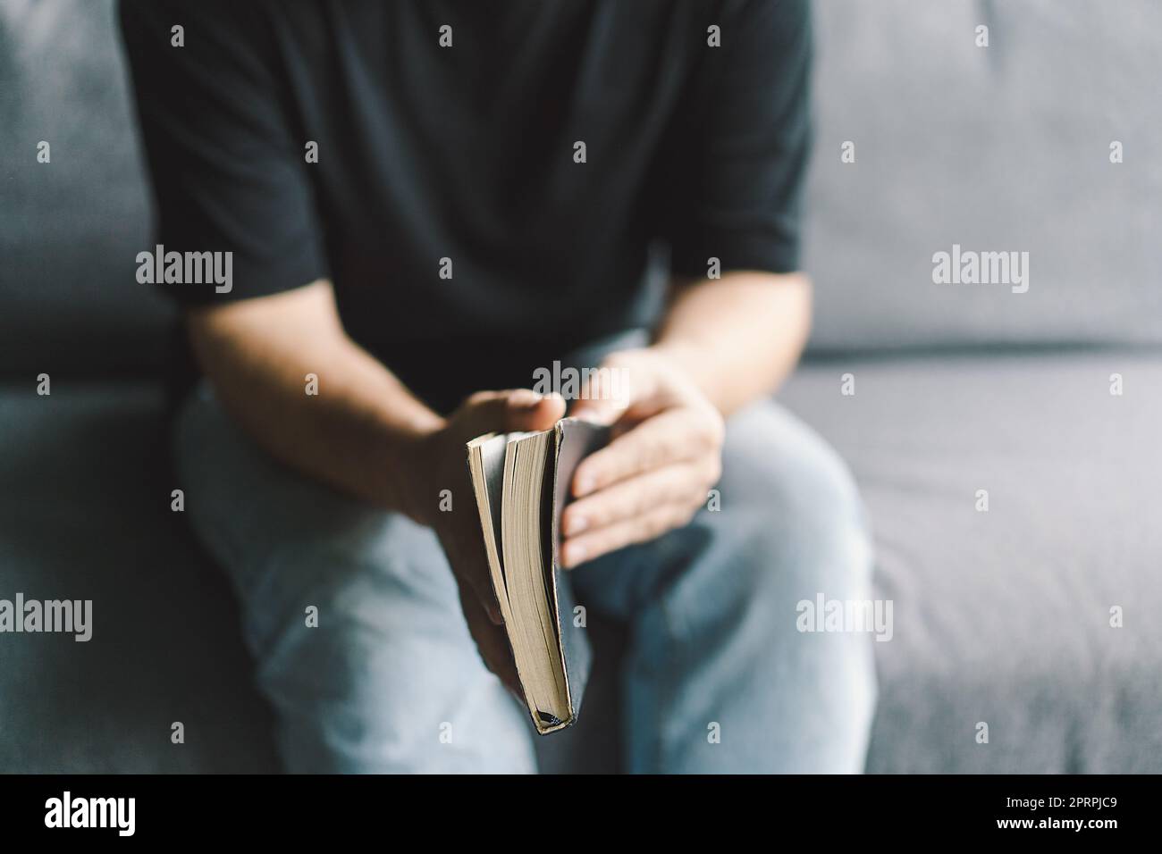 Christian man holds holy bible in hands. Reading the Holy Bible in a ...