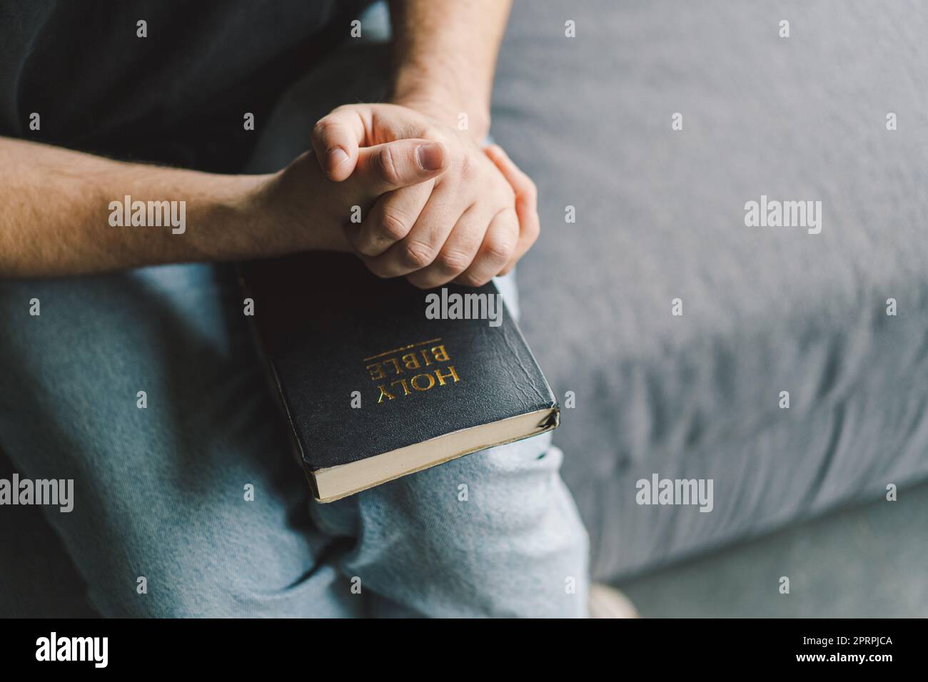 Christian man holds holy bible in hands. Reading the Holy Bible in a ...