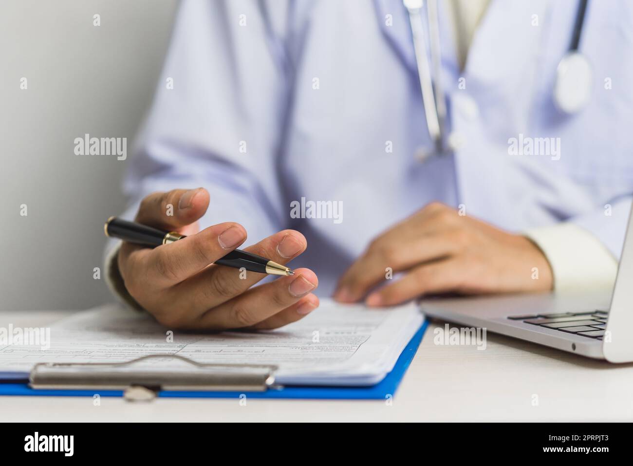Doctor hand holding pen write and paperwork document patient treatment ...