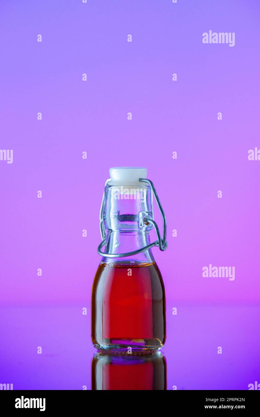 front view bottle with oil on light purple background Stock Photo - Alamy