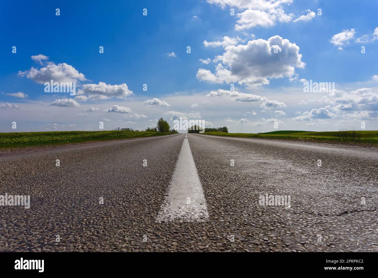 Low angle view of a tarred road receding Stock Photo - Alamy