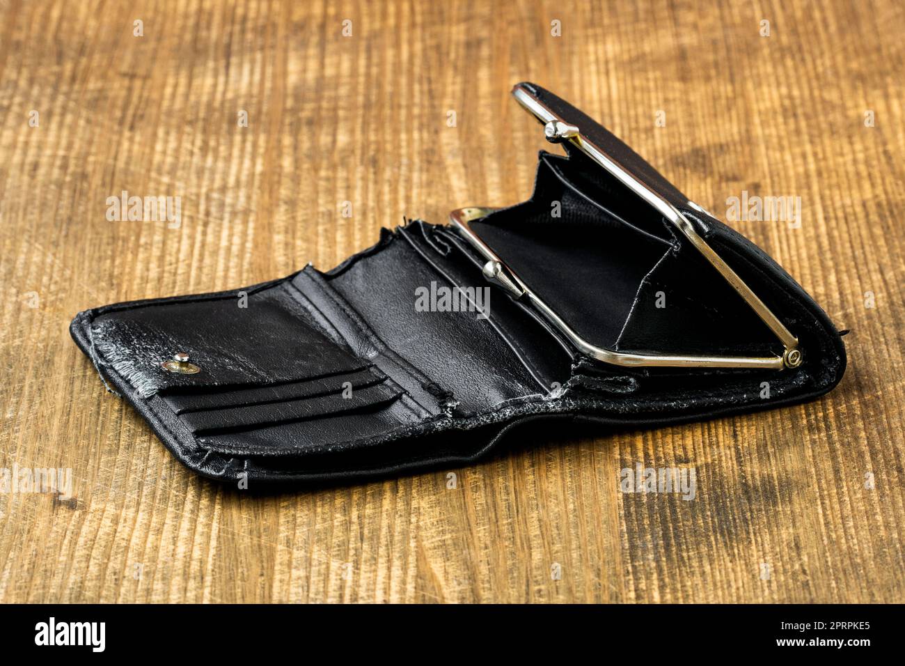 Old empty leather wallet on a wooden background Stock Photo - Alamy