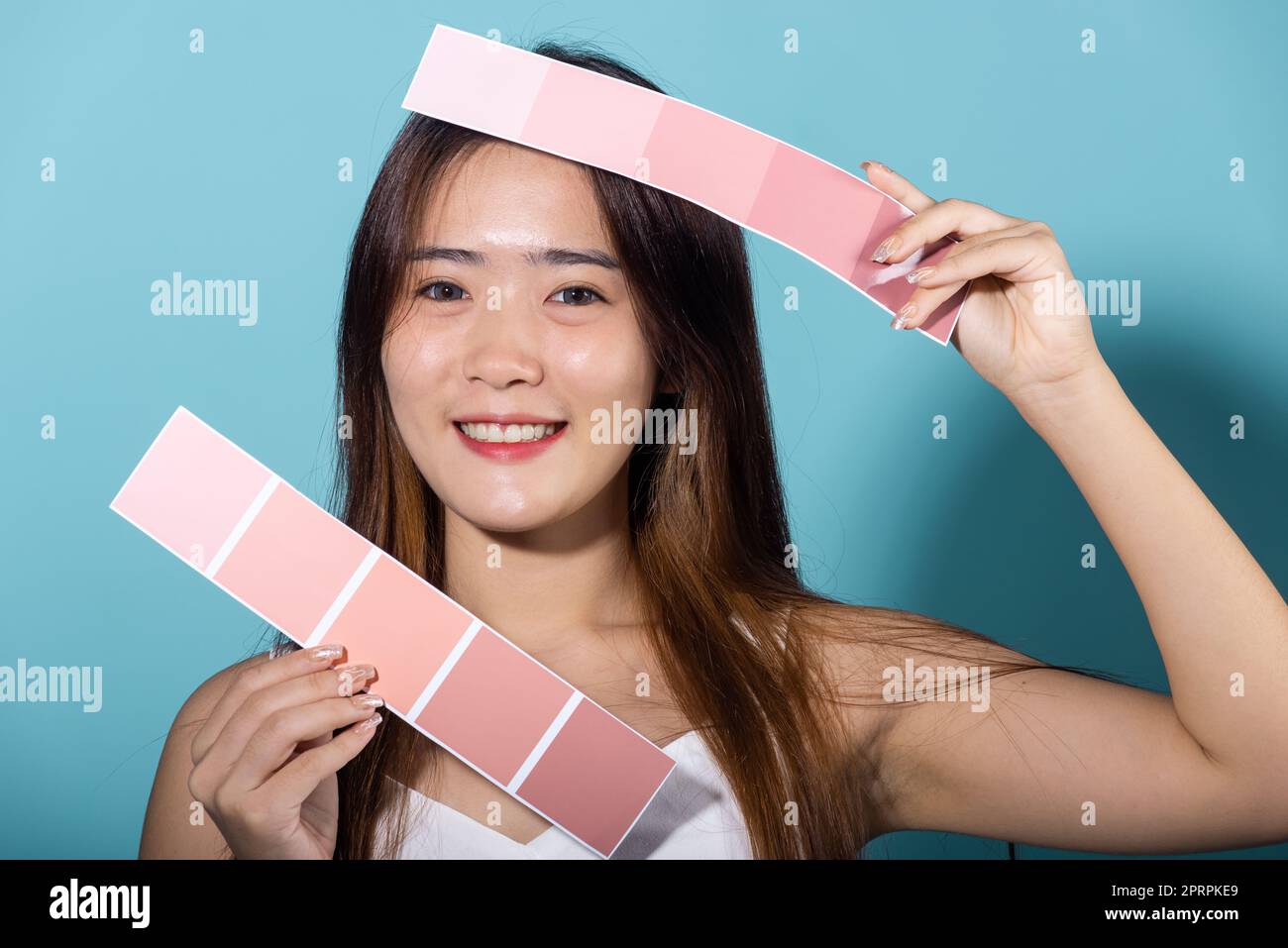 Portrait of happy female hold color card under sun protection Stock ...
