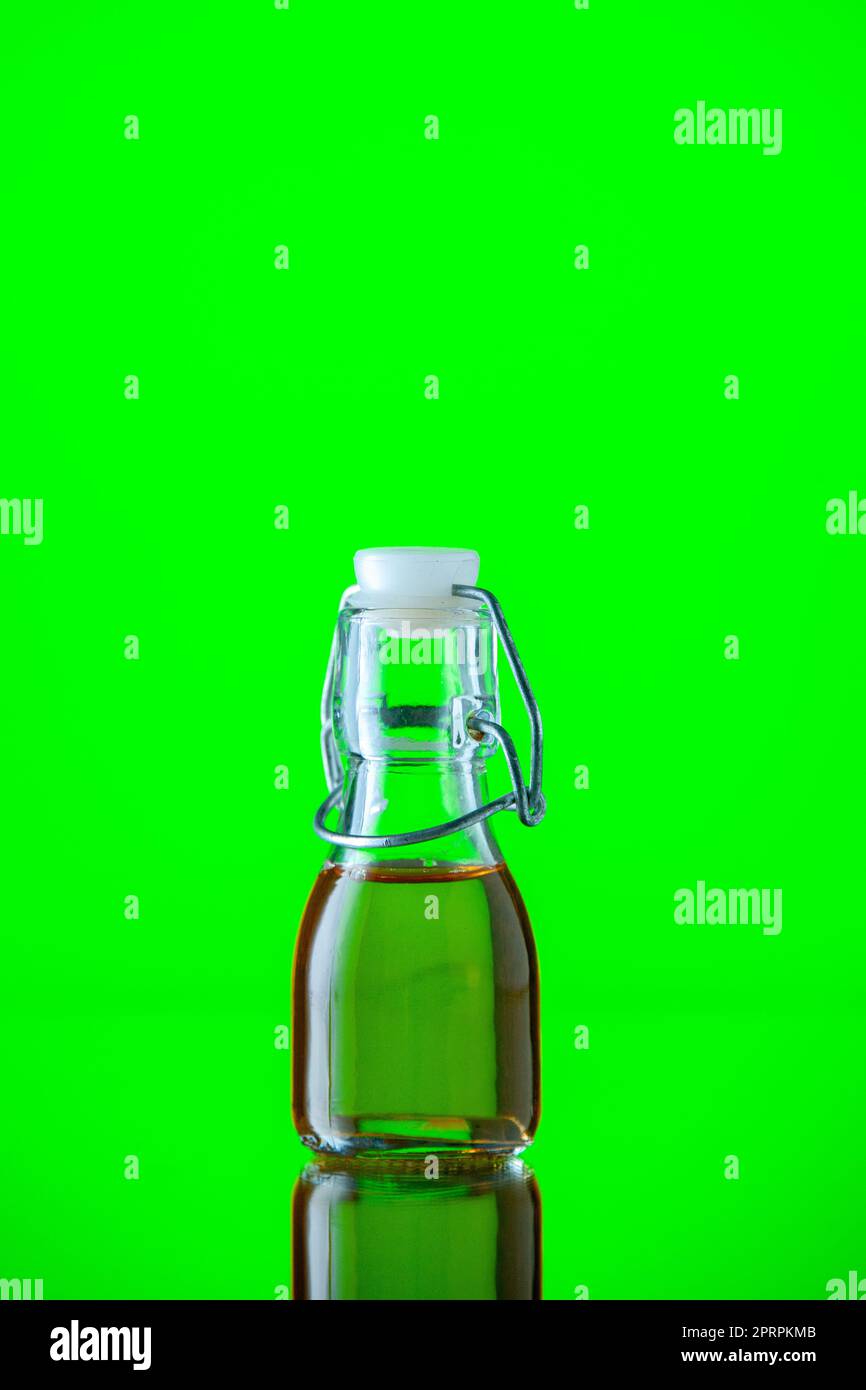 front view bottle with oil on neon green background Stock Photo - Alamy