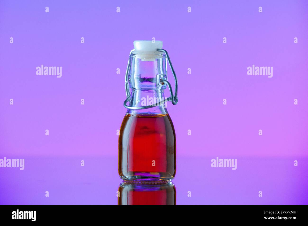 front view bottle with oil on purple background free space Stock Photo ...