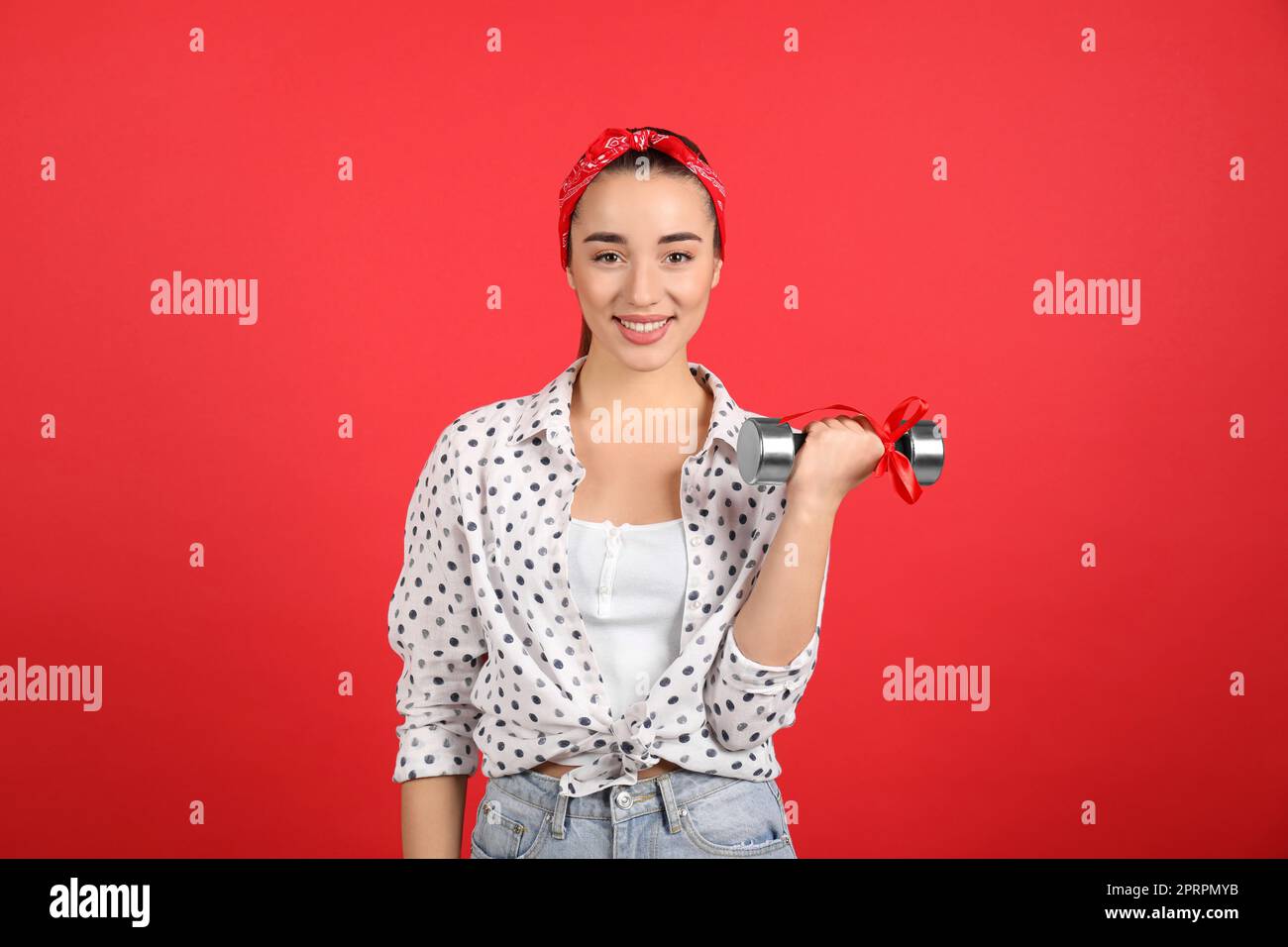 Woman with dumbbell as symbol of girl power on red background. 8 March ...
