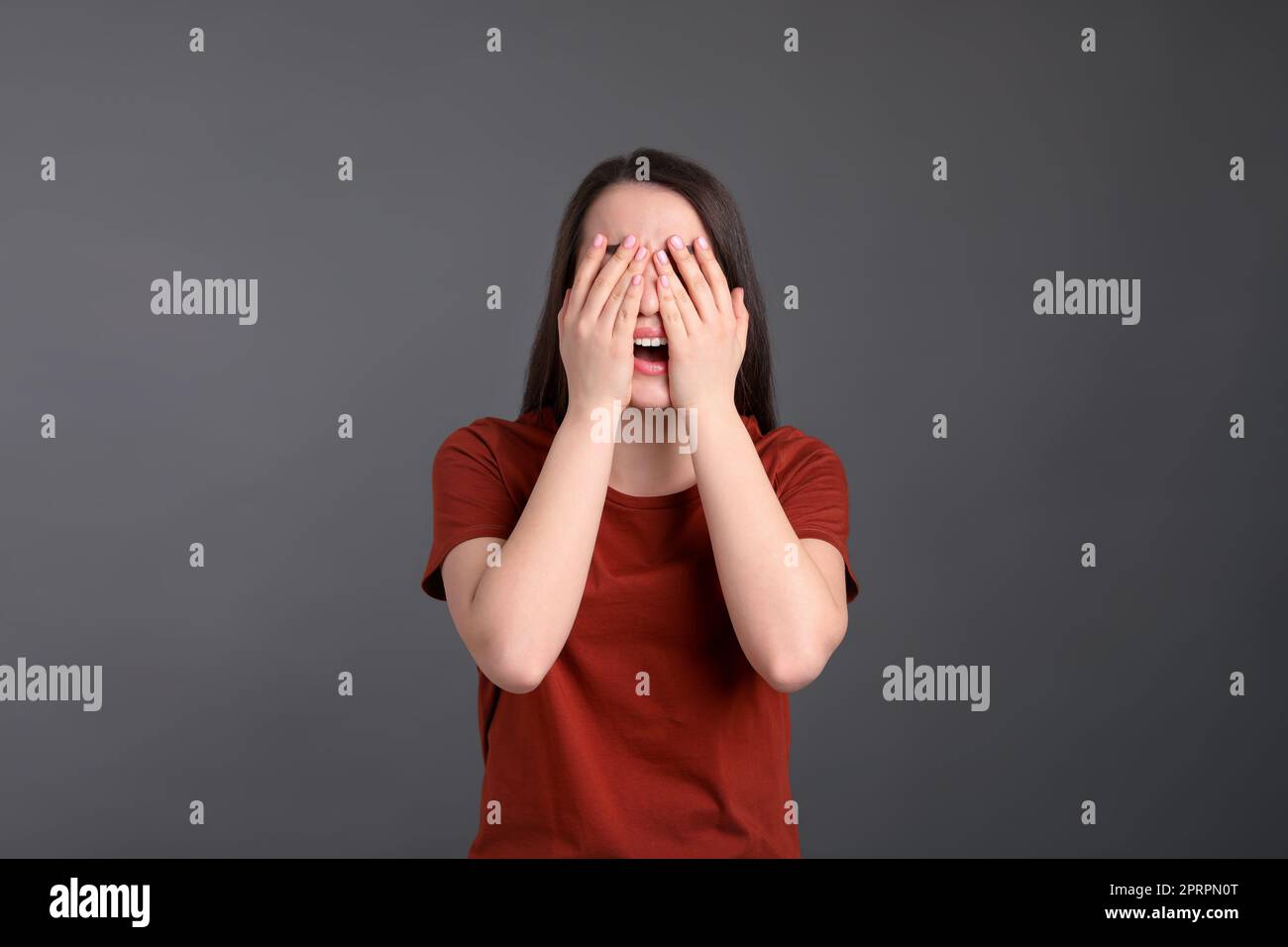 Emotional young woman on dark grey background. Personality concept ...