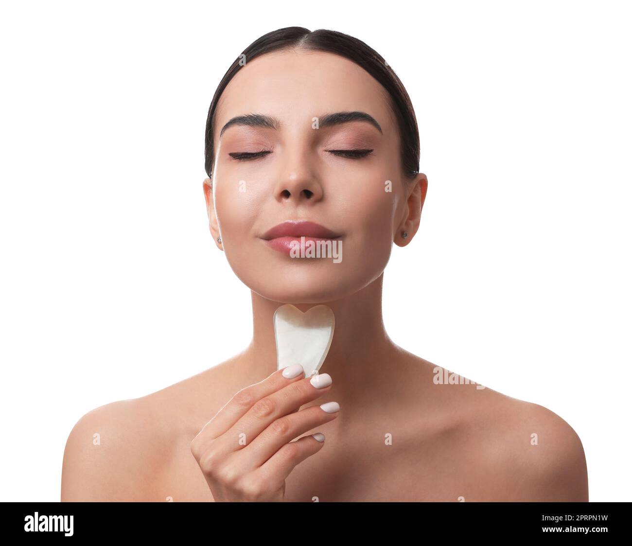 Beautiful Young Woman Doing Facial Massage With Gua Sha Tool On White