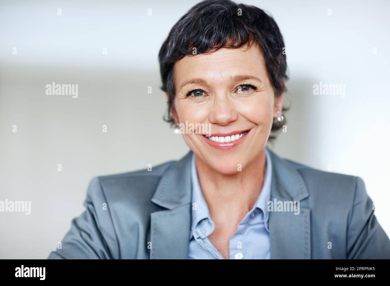 Female executive smiling. Portrait of successful mature female ...