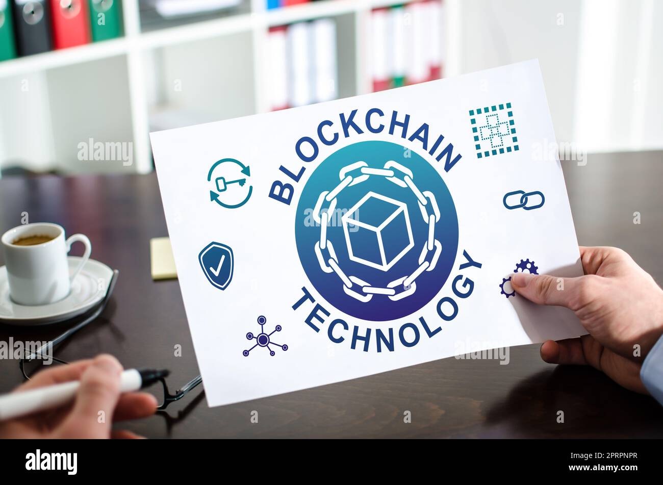 Hand holding a paper showing blockchain concept Stock Photo - Alamy