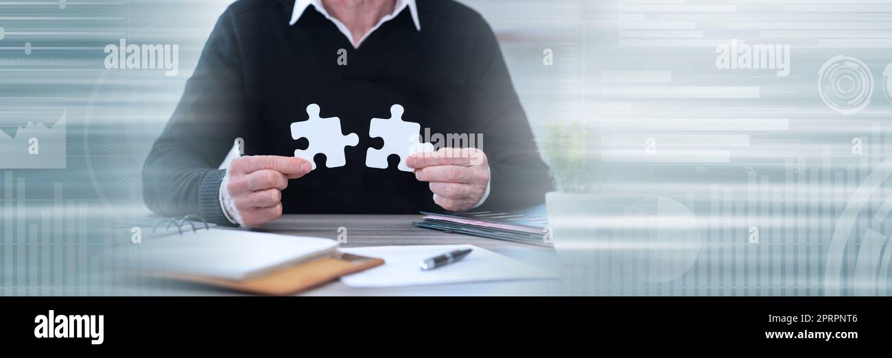Hands of businessman joining two puzzle pieces, teamwork concept ...