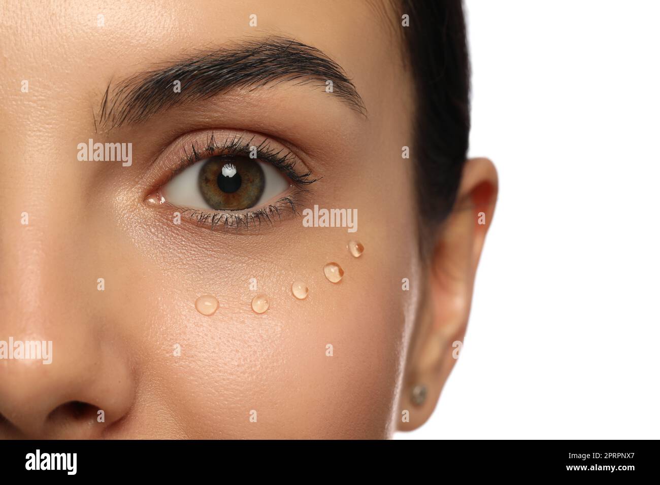 Closeup view of young woman with gel on skin under eye against white ...