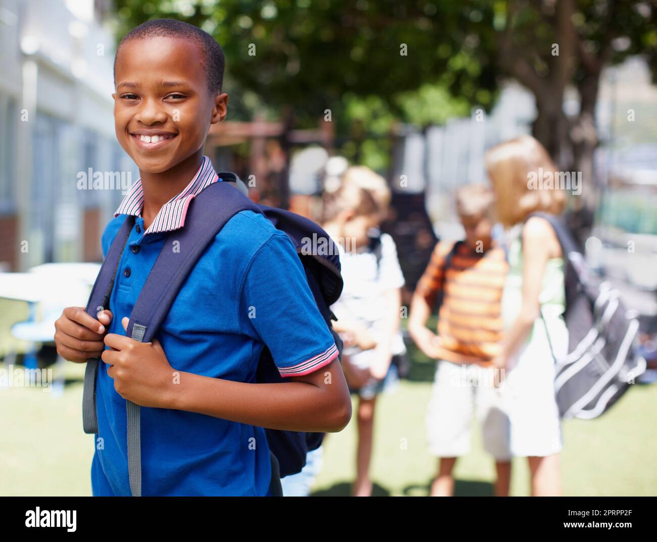 I cant wait to get to class. Smiling african american boy posing ...