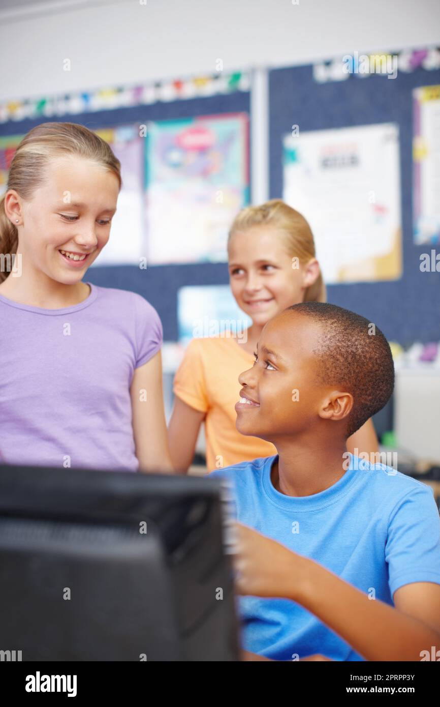 Playing computer games during break. Three school kids sitting and ...