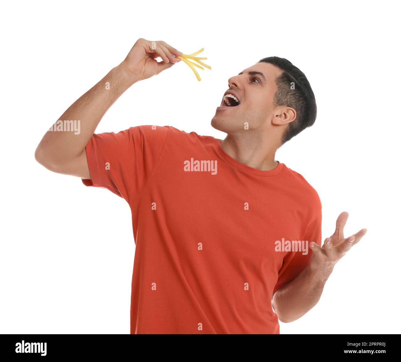 Man eating French fries on white background Stock Photo - Alamy