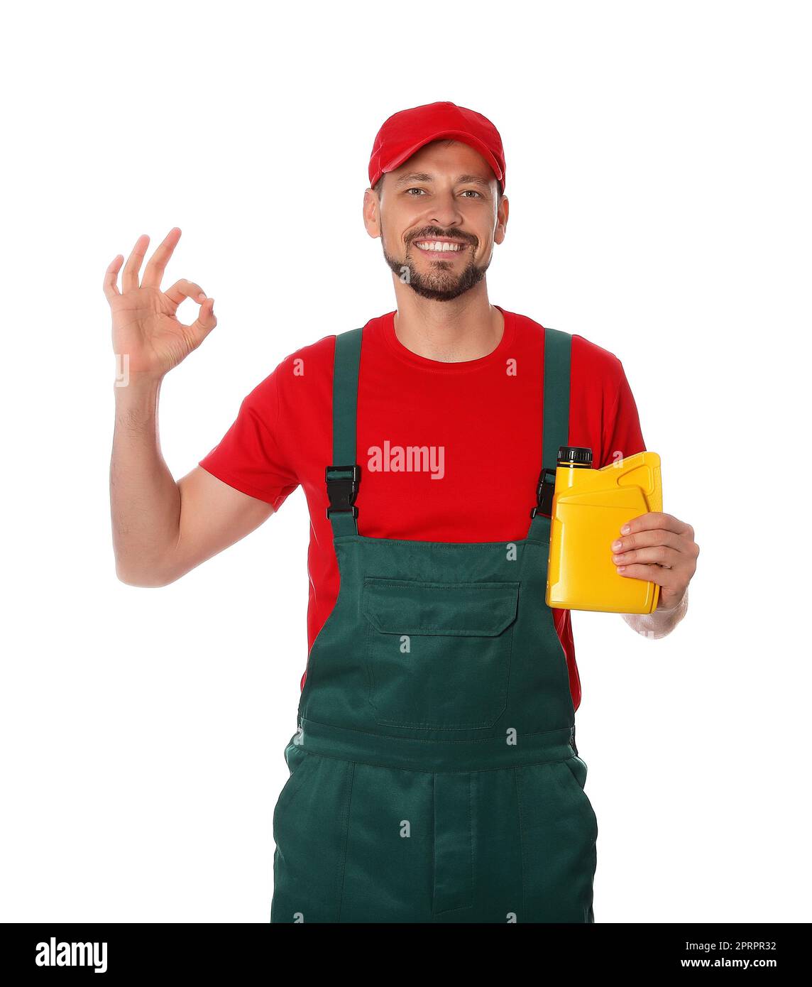 Man holding yellow container of motor oil and showing OK gesture on ...