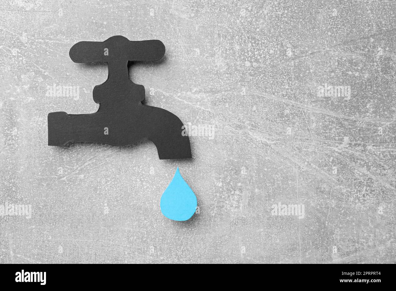 Save water concept. Paper tap with drop on light grey table, flat lay ...