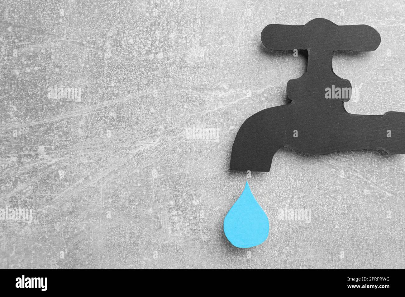 Save water concept. Paper tap with drop on light grey table, flat lay ...