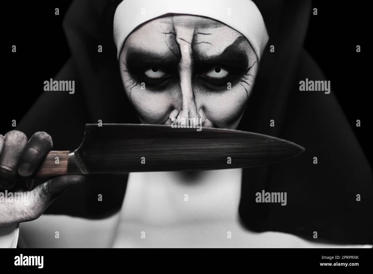 Scary devilish nun with knife on black background, closeup. Halloween ...