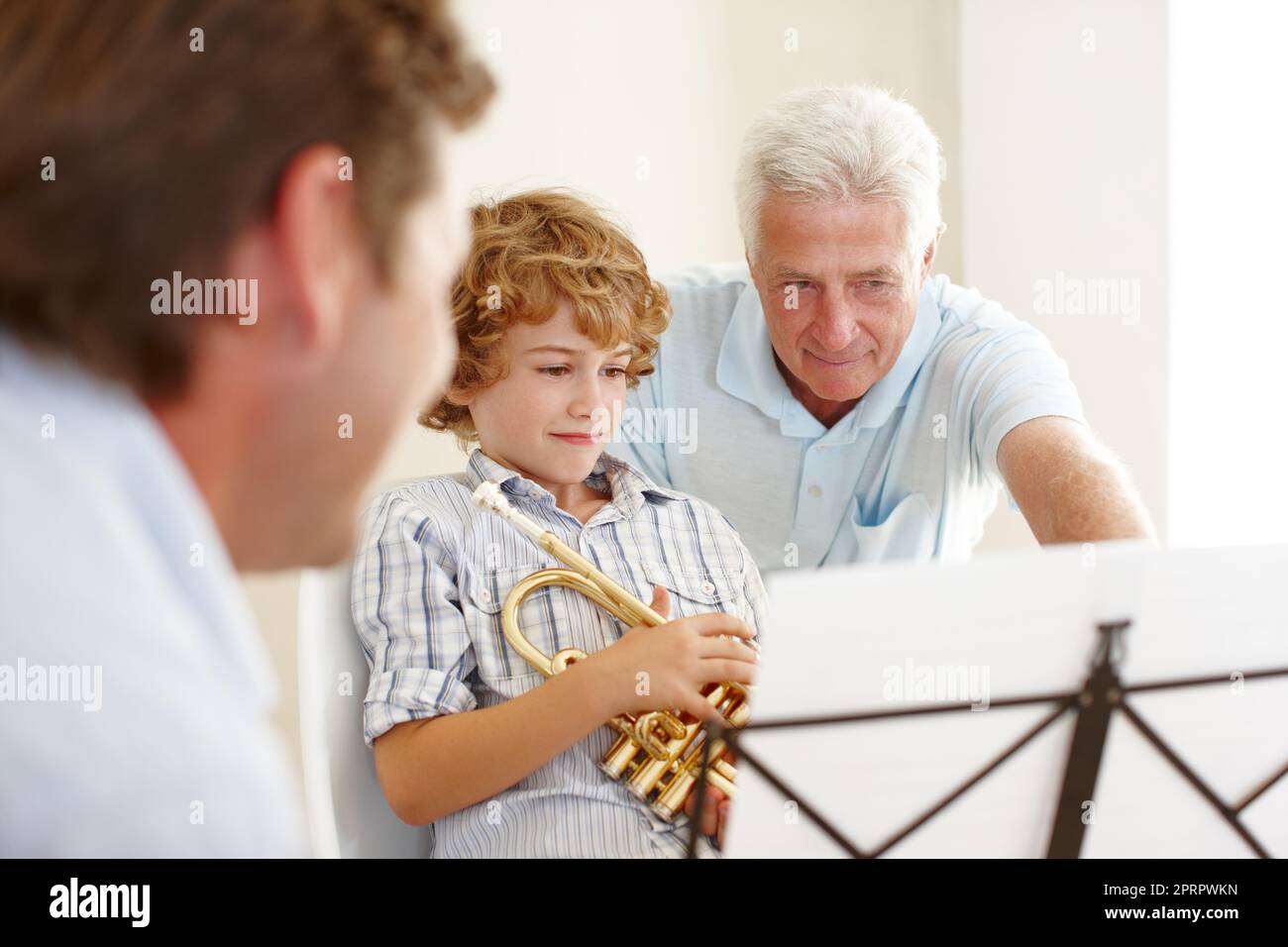 Passing on his musical wisdom. a grandfather teaching his grandson how ...