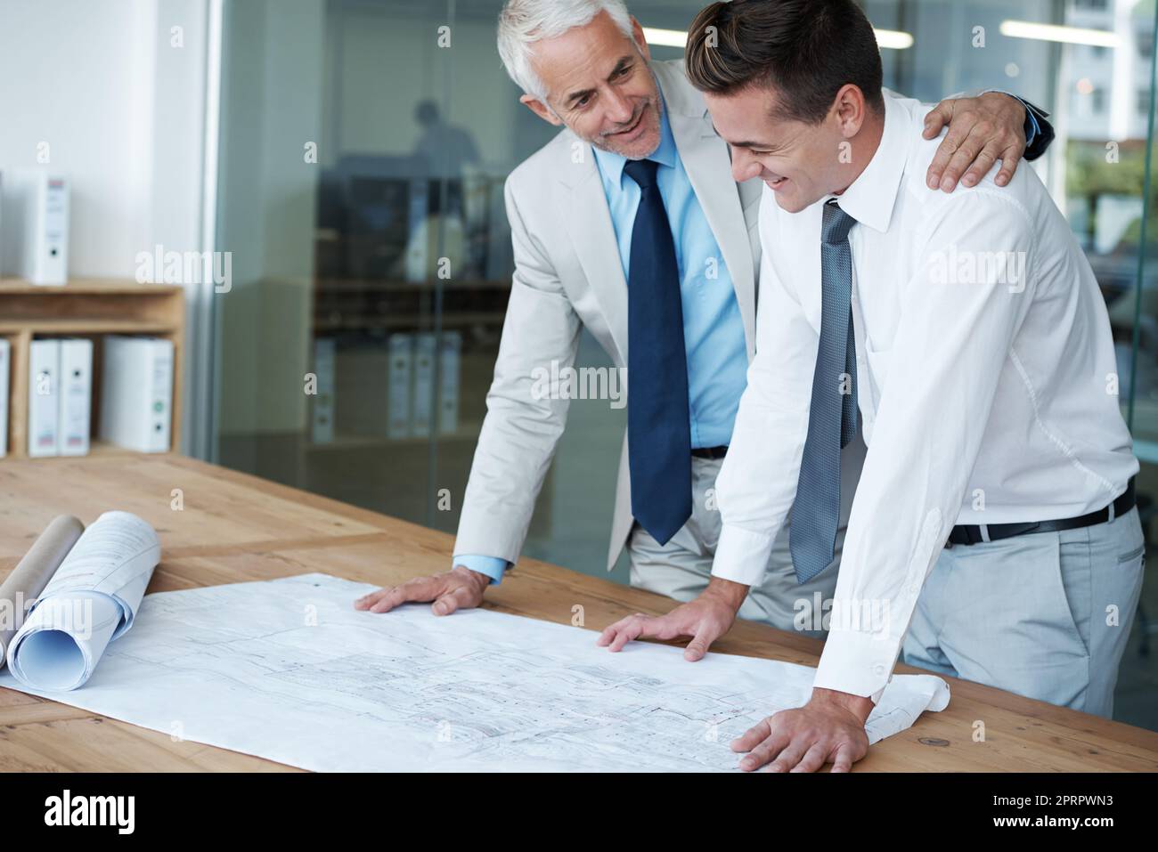 Ensuring the blueprints are perfect. two architects going over a ...